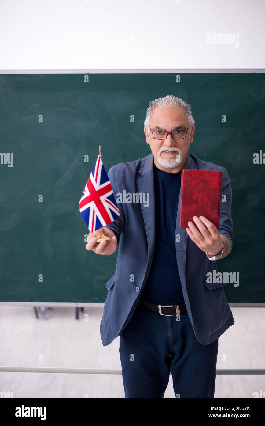 Old male english language teacher in the classroom Stock Photo - Alamy