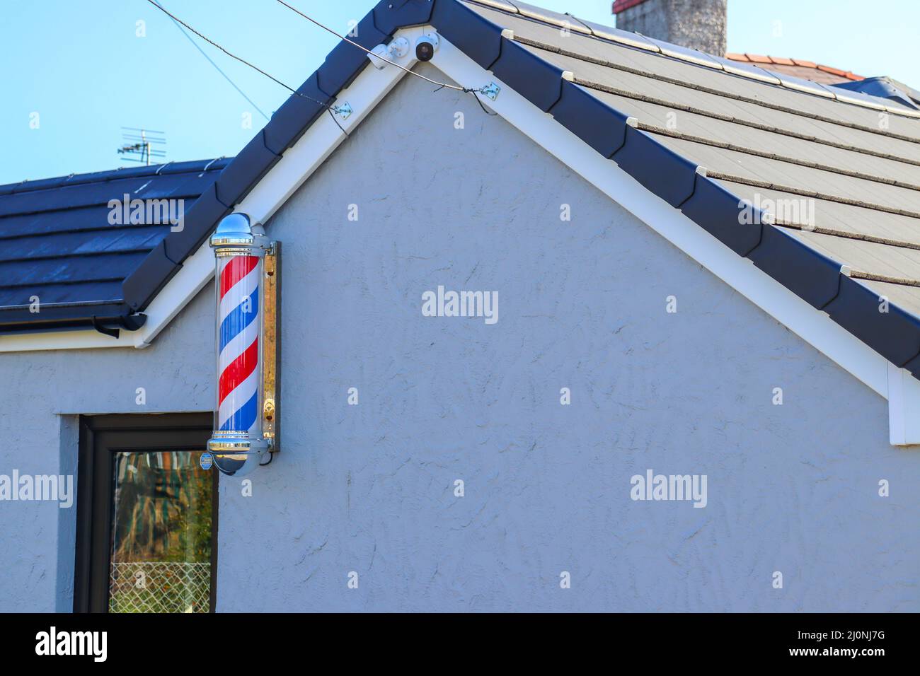 Blue and red rotating barbers pole Stock Photo - Alamy