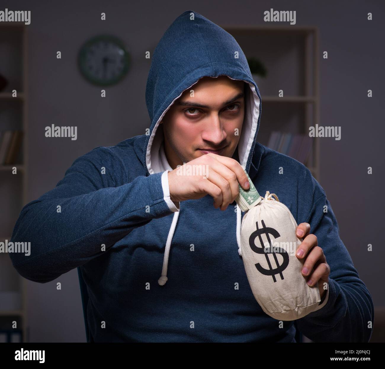 Hacker with sack of money Stock Photo - Alamy