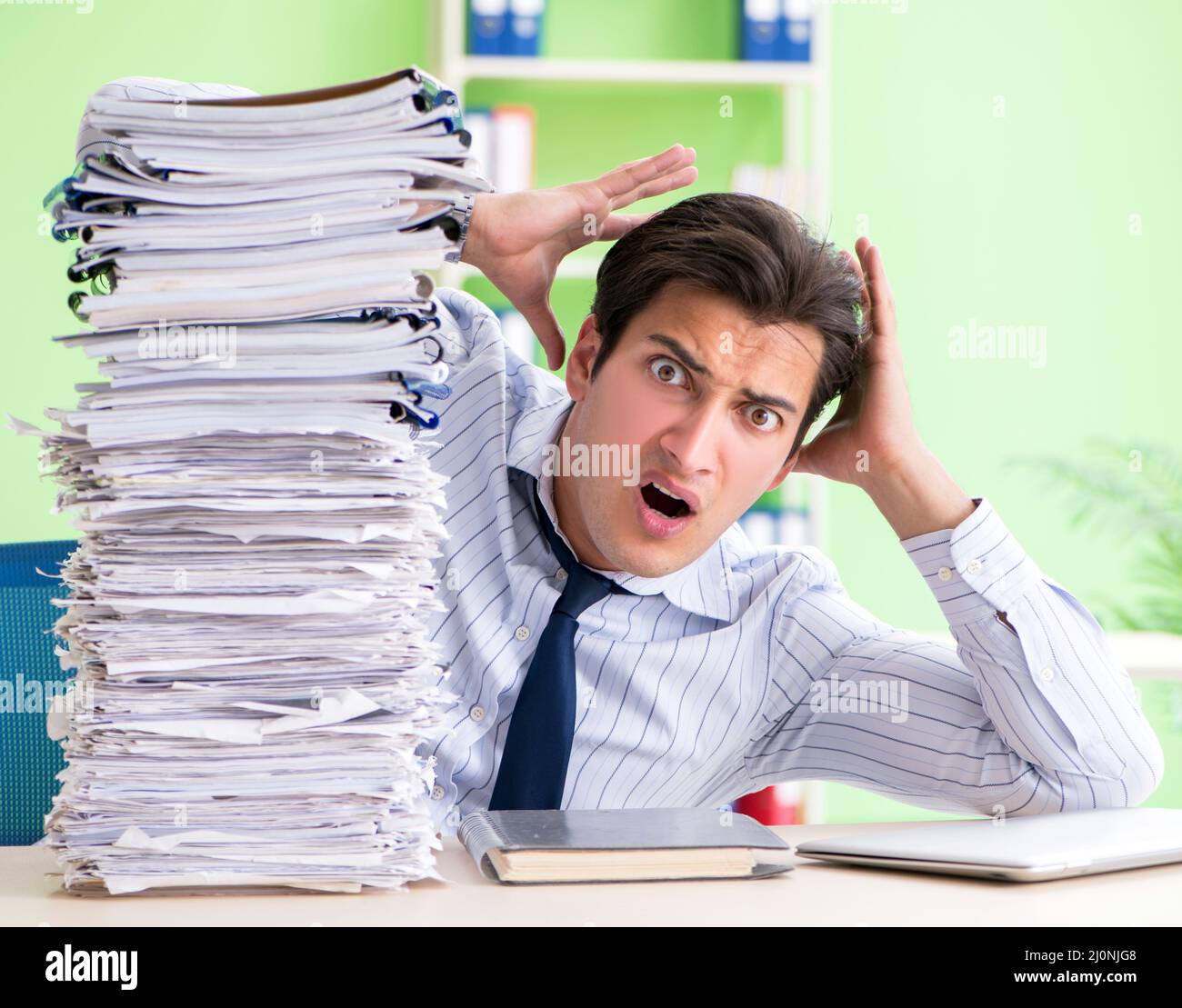 Businessman having problems with paperwork and workload Stock Photo - Alamy