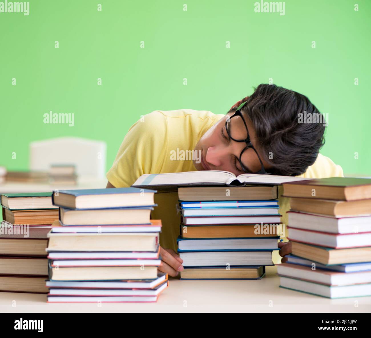 Student with too many books to read before exam Stock Photo - Alamy