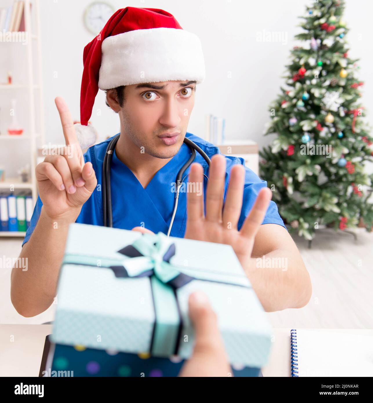 Doctor with gift box in the hospital Stock Photo - Alamy