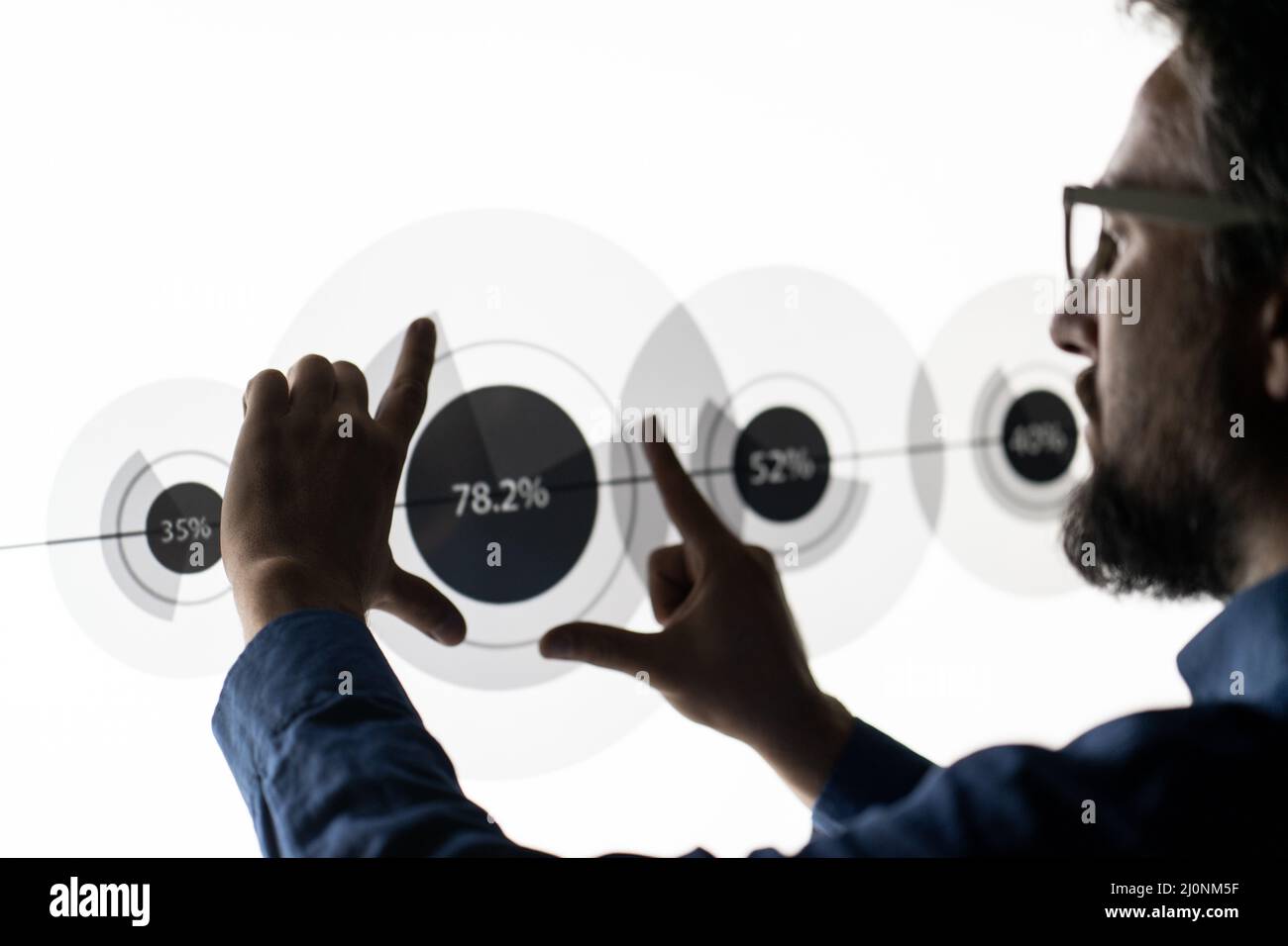 Close up of hand using creative business chart hologram settings on ...