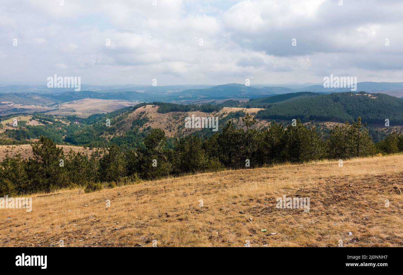 Dry hill overlooking scenic mountain ranges Stock Photo - Alamy