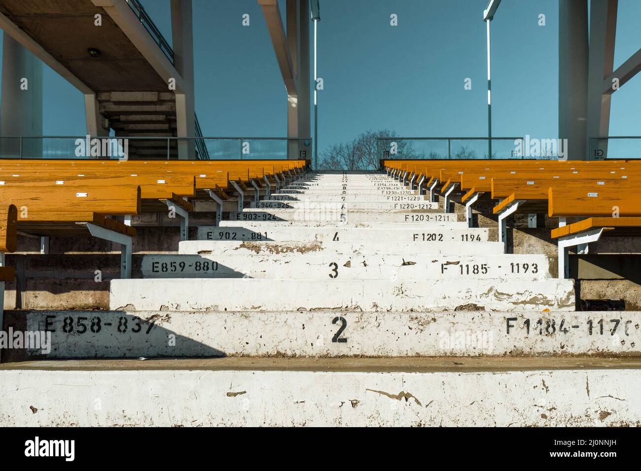 Numbered steps in the sports stadium between the wooden seats over the ...