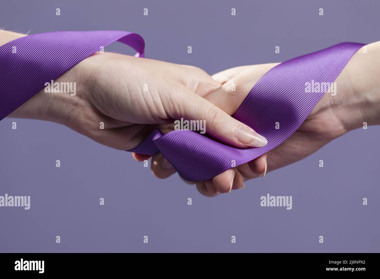 Women hands holding purple satin ribbon. High quality and resolution ...