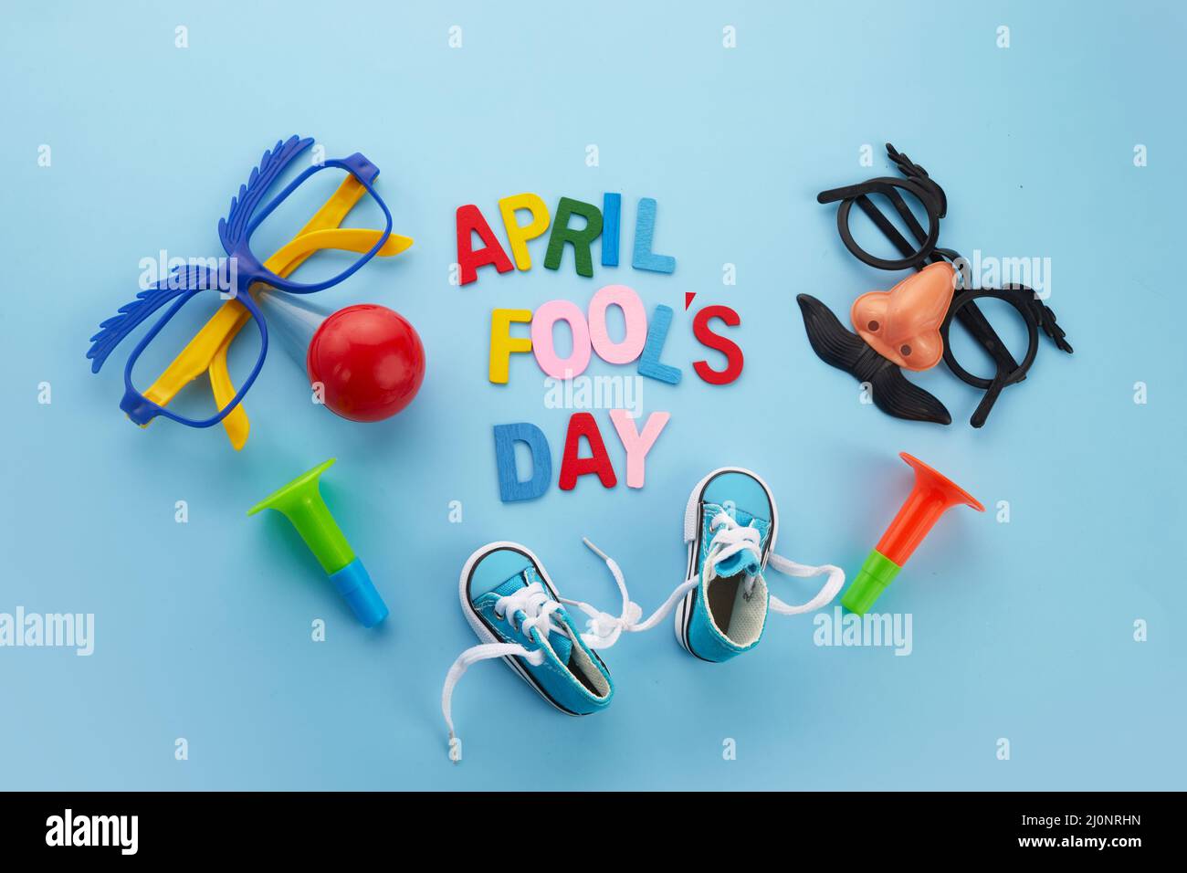April Fools Day text and funny glasses and pair of shoes with the laces ...