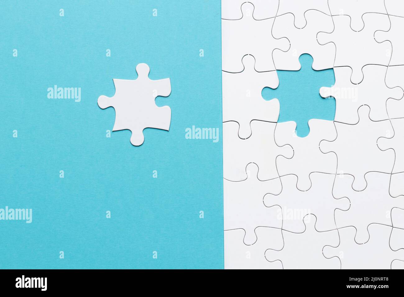 Single white jigsaw puzzle piece blue background . High quality and ...