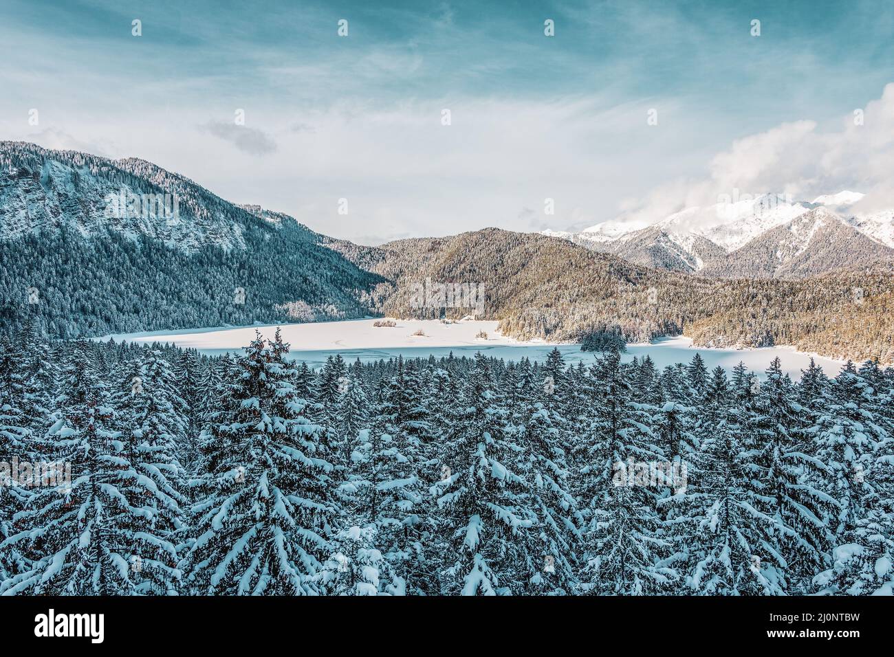 Snowy mountains and trees in the alps. View of the lake Eibsee. Germany ...