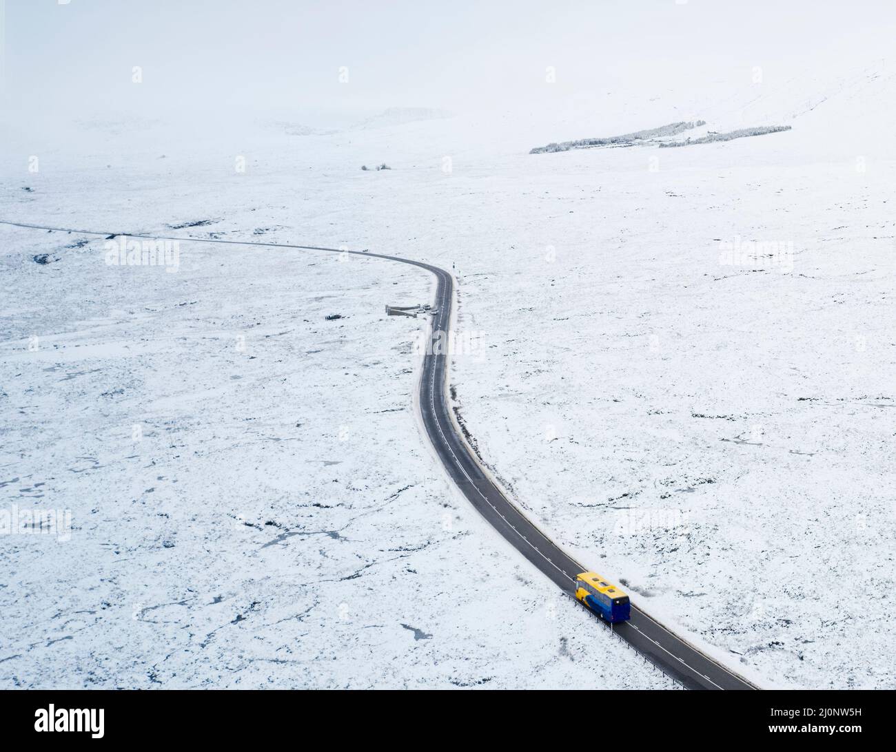 Aerial view of A82 road through Rannoch Moor and Black Mount covered in ...