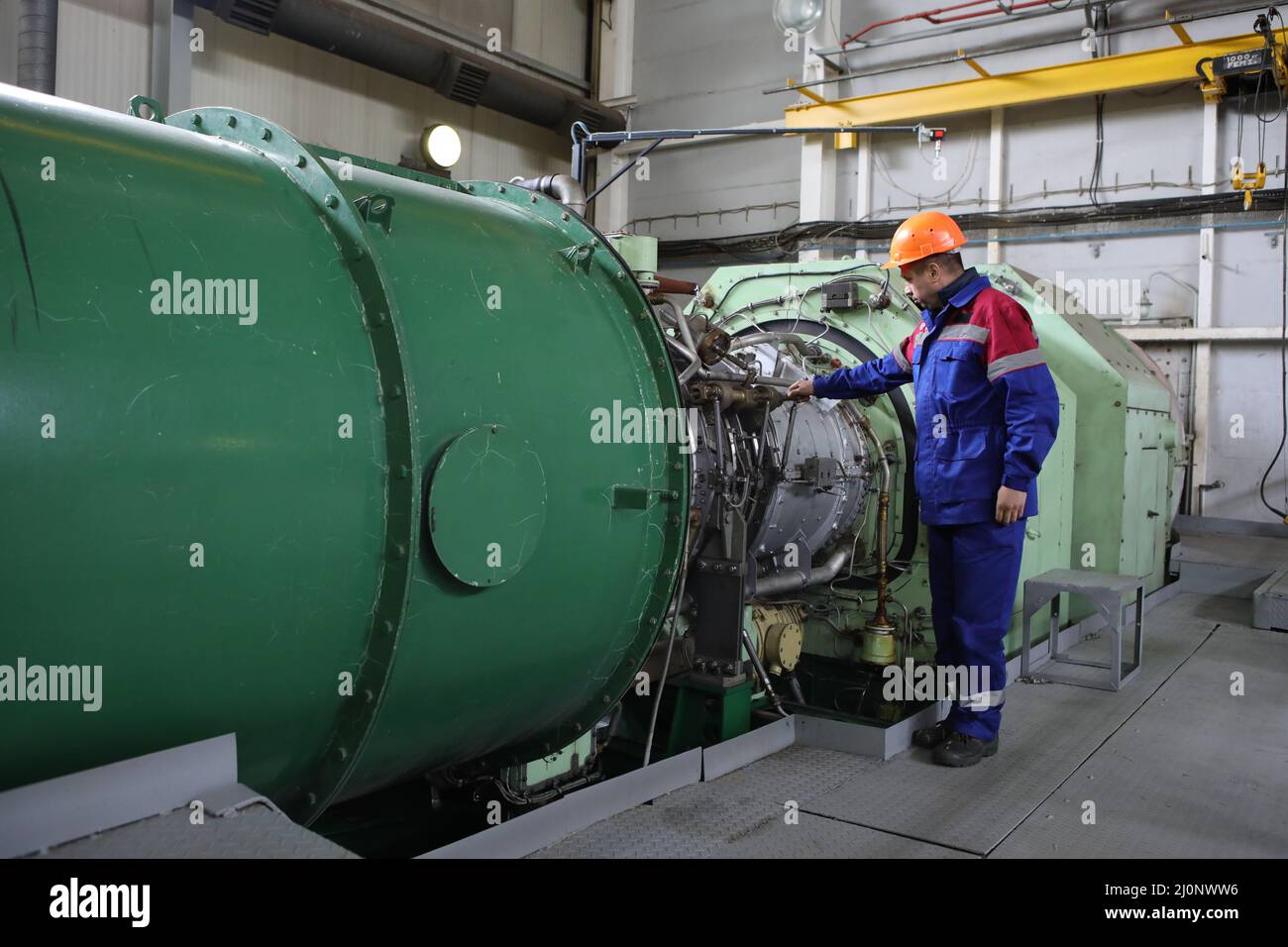 Oil and gas. A man repairs turbine. Maintenance of a gas station by a ...