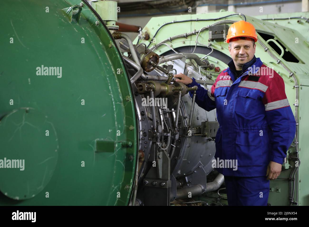 Oil and gas. A man repairs turbine. Maintenance of a gas station by a ...