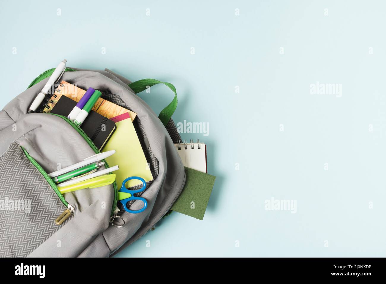 Opened backpack with school supplies . High quality and resolution ...