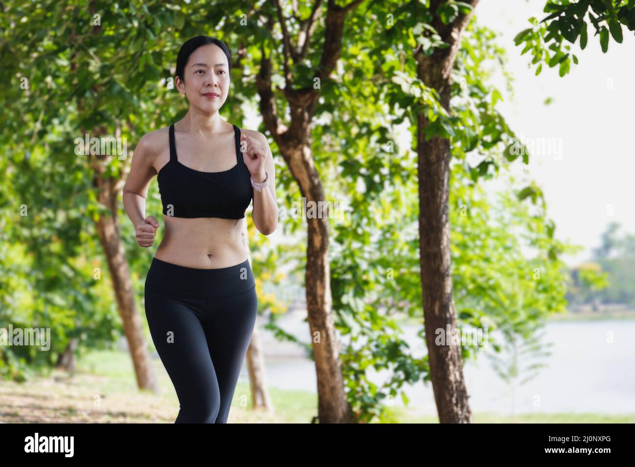 Woman running outside in park in beautiful summer Stock Photo - Alamy