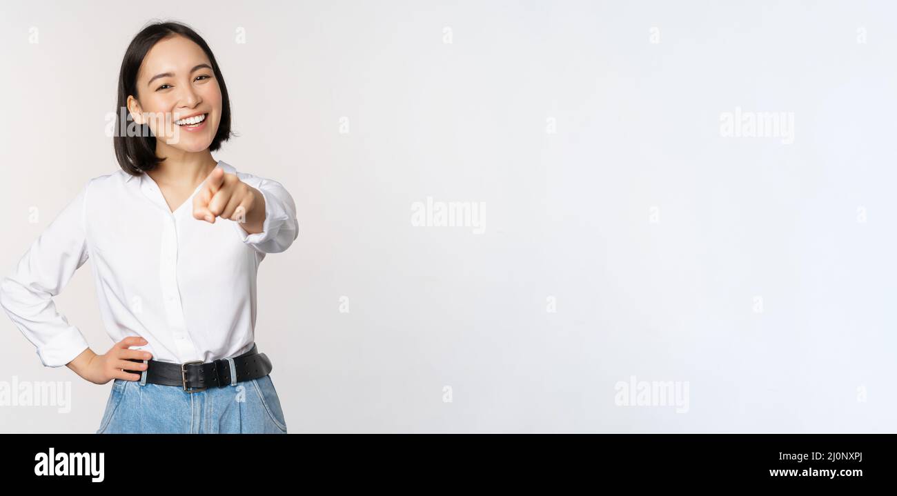Its you. Beautiful young asian woman, company manager pointing finger ...