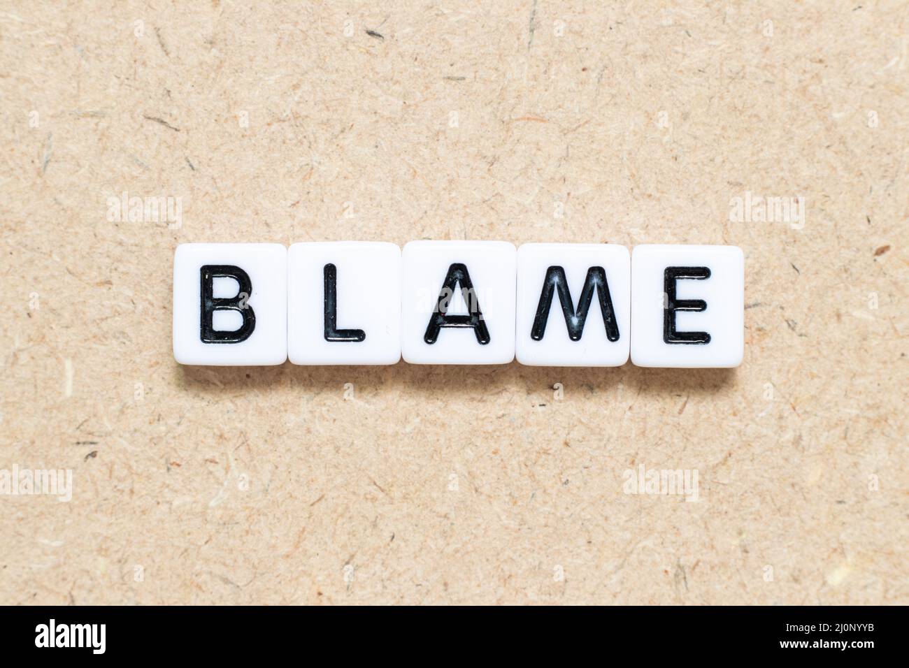 White tile alphabet letter with word blame on wood background Stock ...