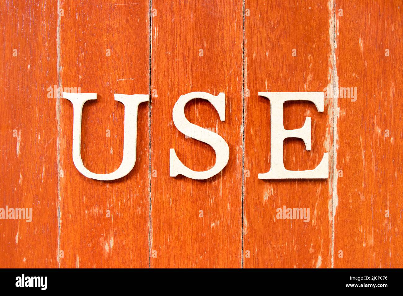 Alphabet letter in word use on old red color wood plate background ...