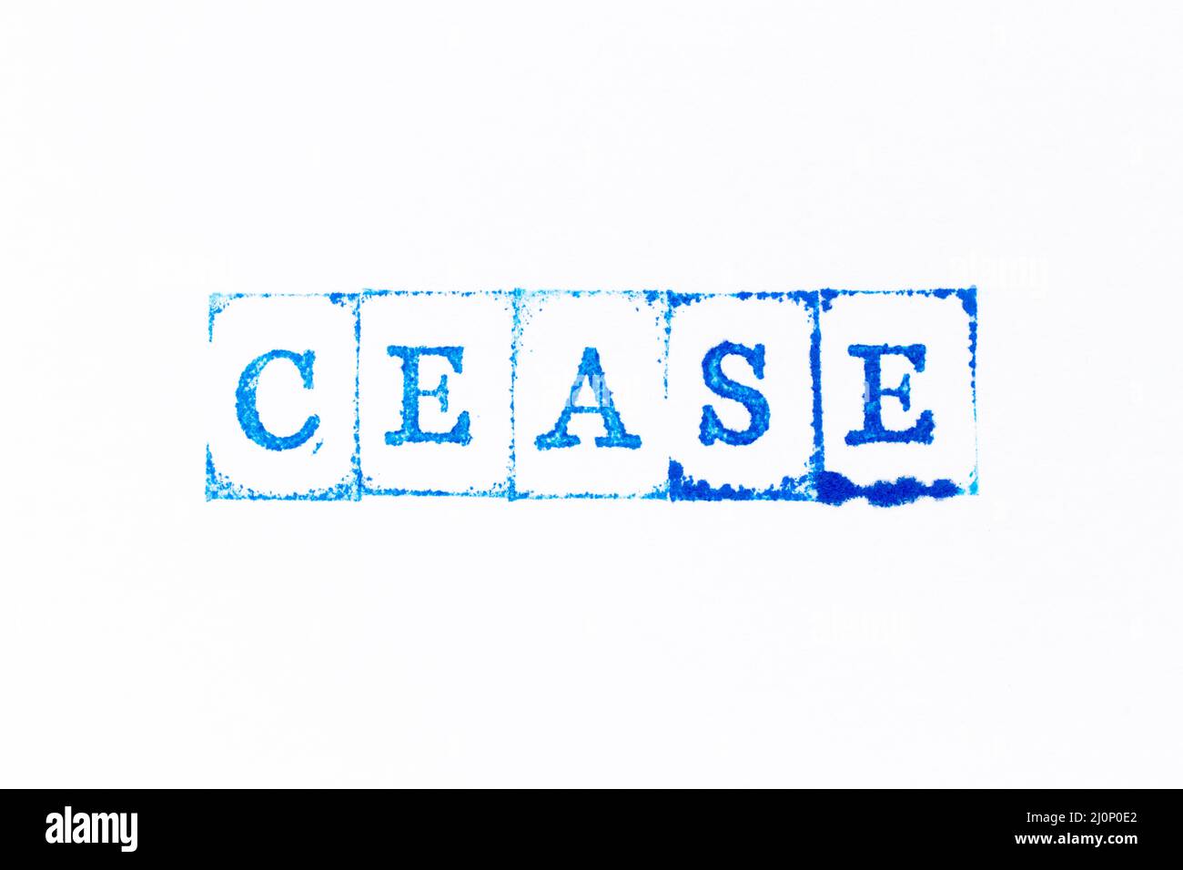 Blue color ink rubber stamp in word cease on white paper background ...