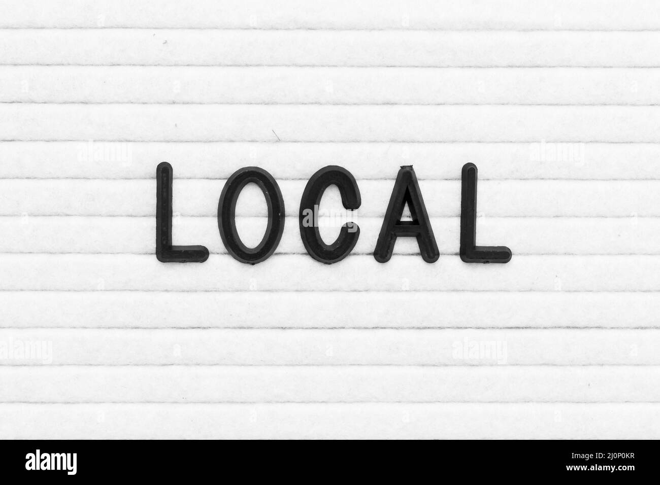 Black color letter in word local on white felt board background Stock ...