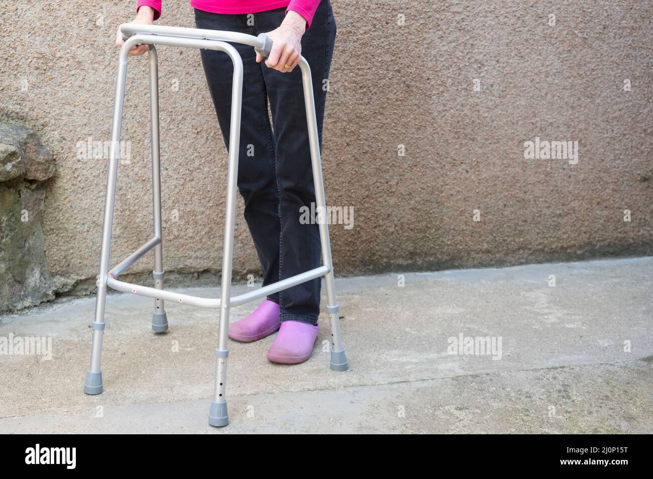 Old person with walking frame inside house Stock Photo - Alamy