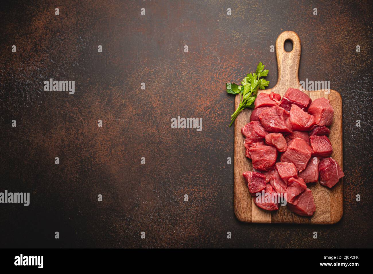 Beef raw meat cubes for stew on wooden cutting board copy space Stock ...