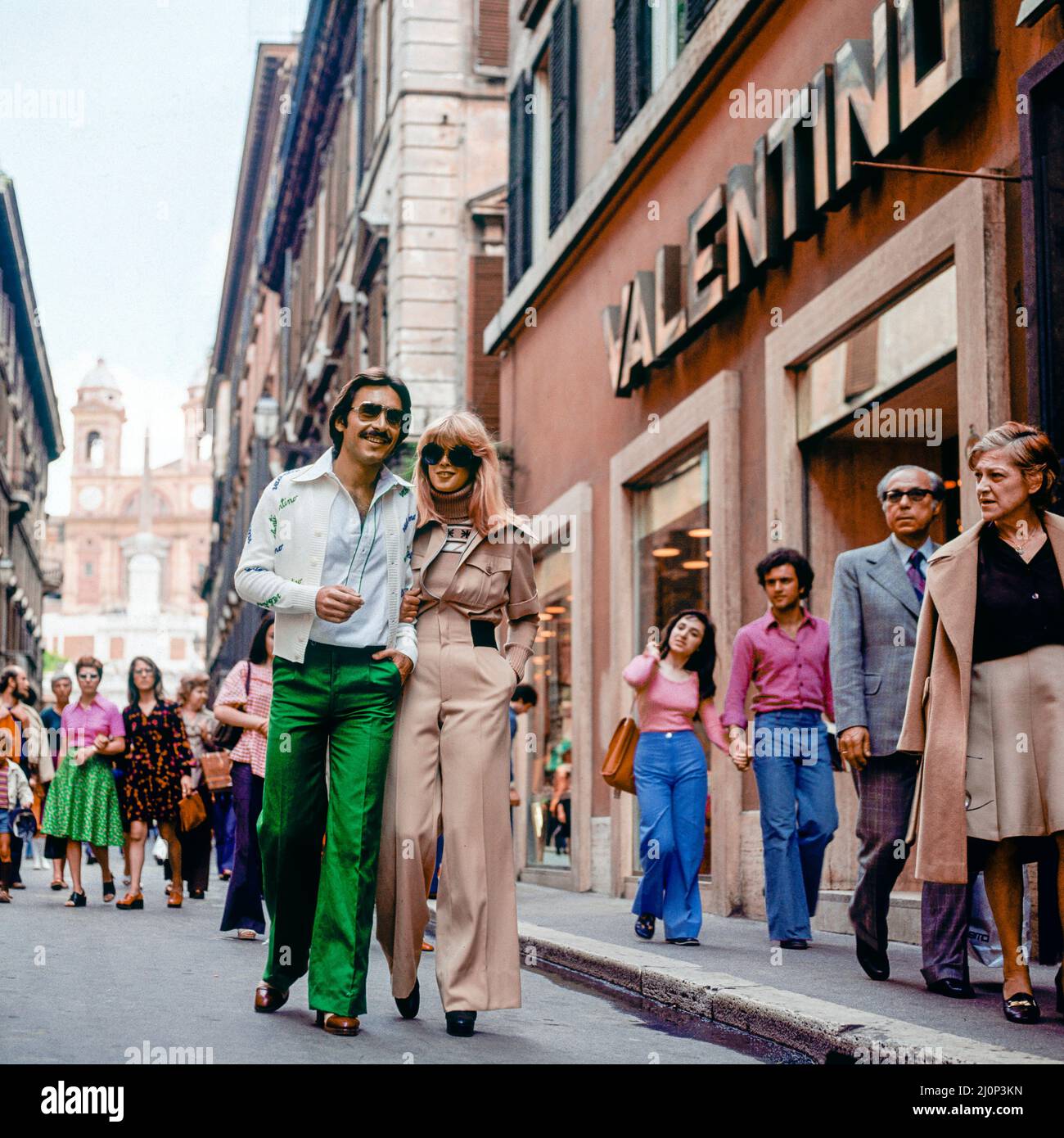 Vintage Rome 1970s, stylish couple strolling by Valentino fashion shop ...