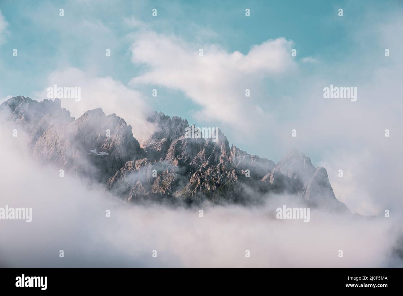 Clouds over mountain peaks in the Dolomites Stock Photo - Alamy