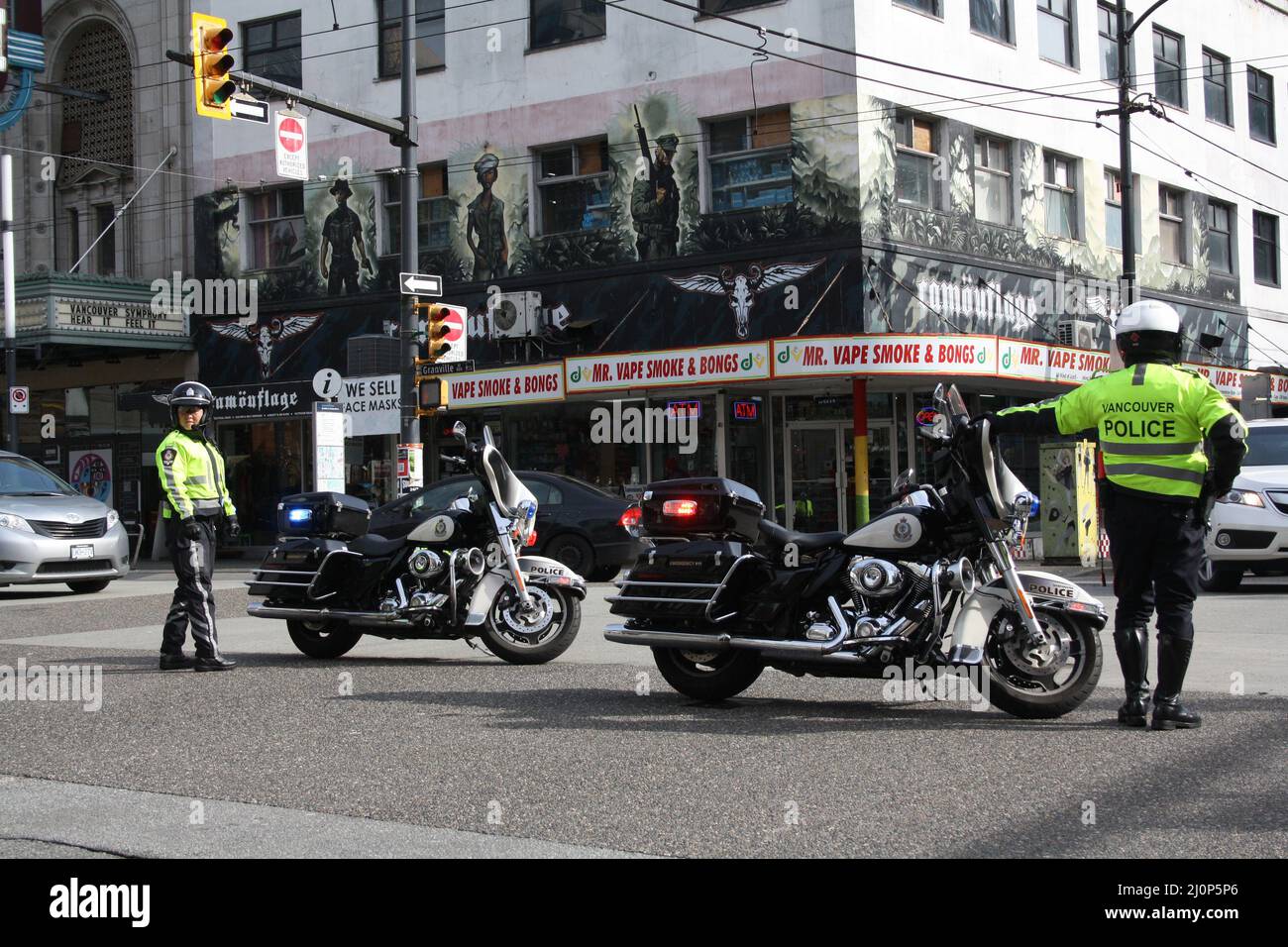 Police standing next to their motorcycles in the street Stock Photo - Alamy