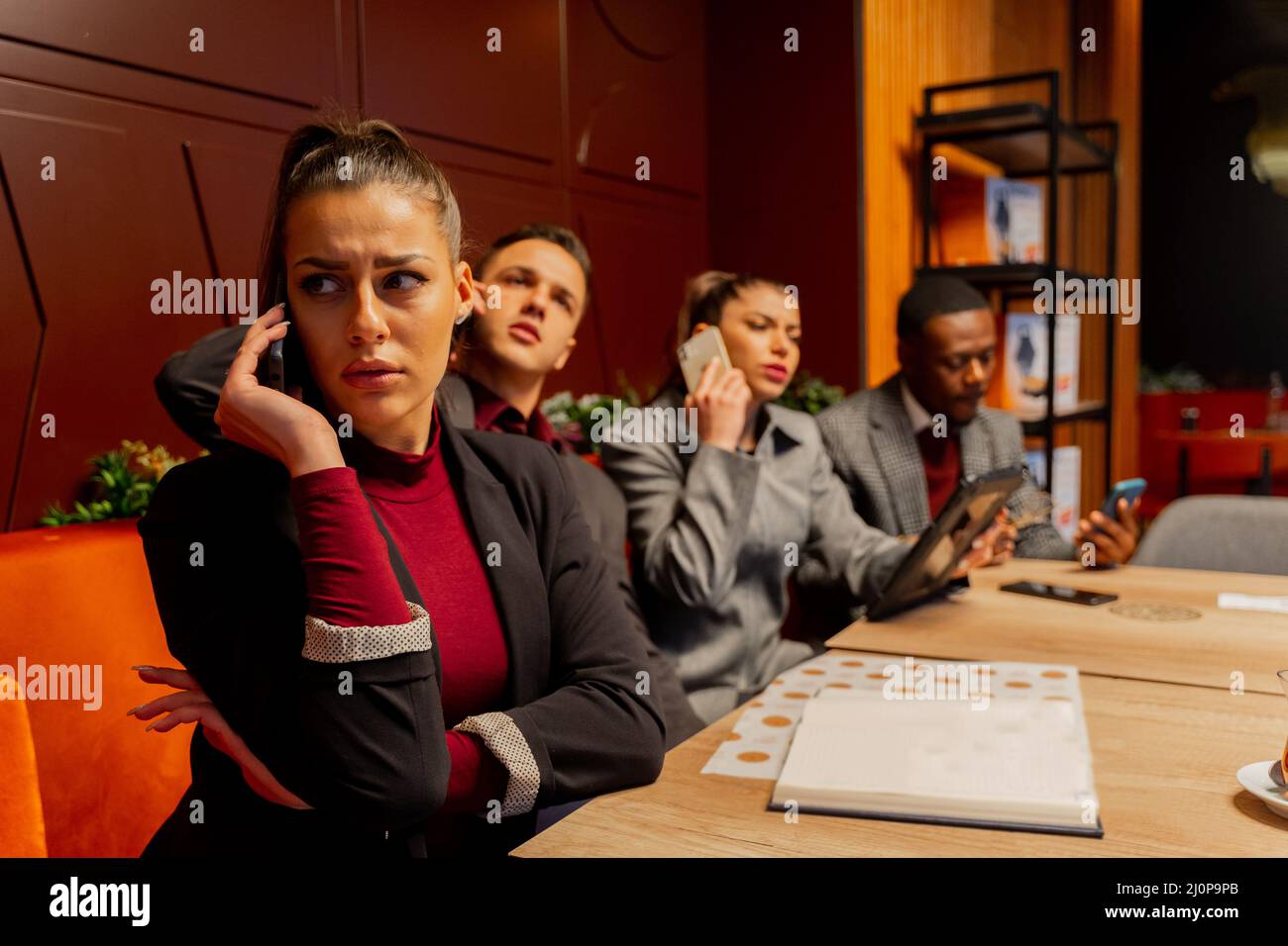 Group of multiracial busniess people are talking on the phone together ...