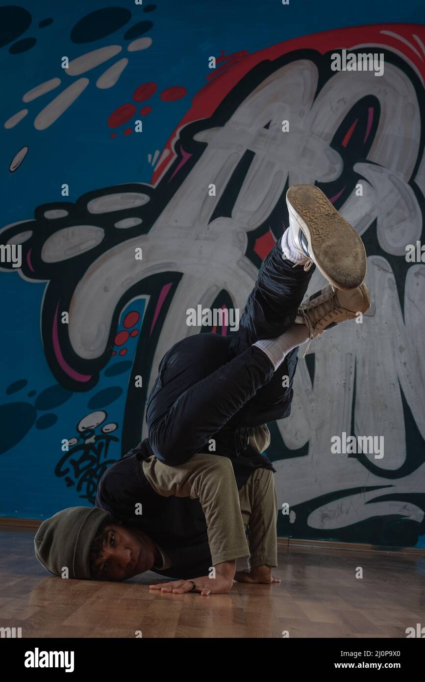 Modern rapper dancing in garage. Urban lifestyle, hip hop Stock Photo ...