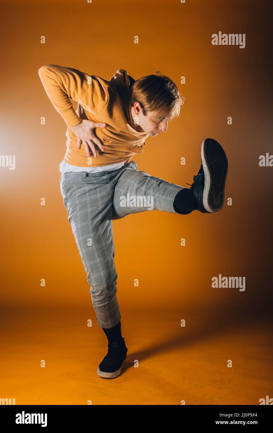 Flexible young dancer performing a stylish dance movement Stock Photo ...