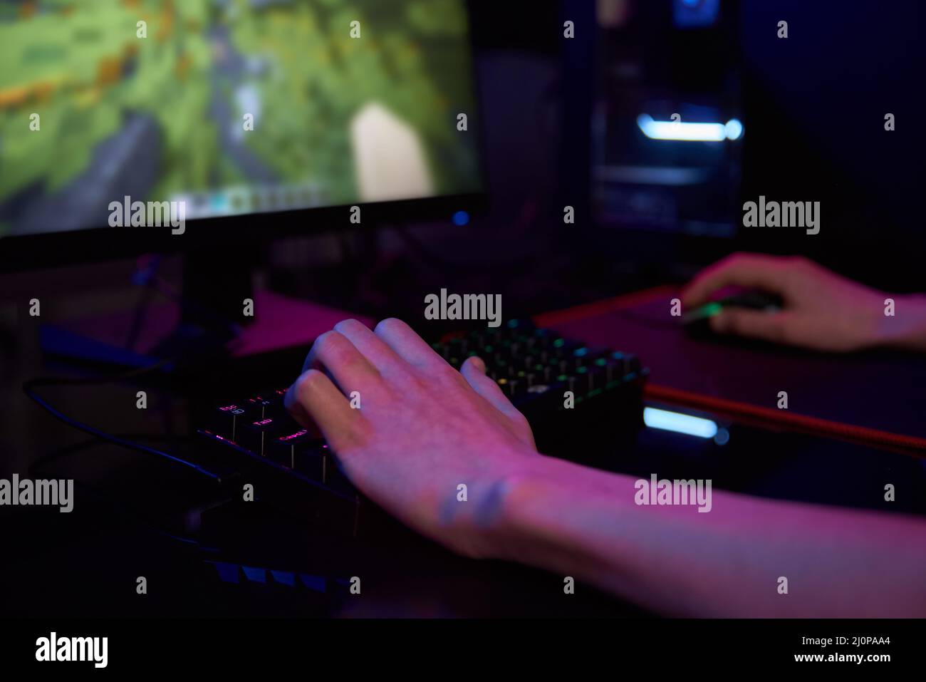 Professional gamer play computer video game in dark room, use neon ...