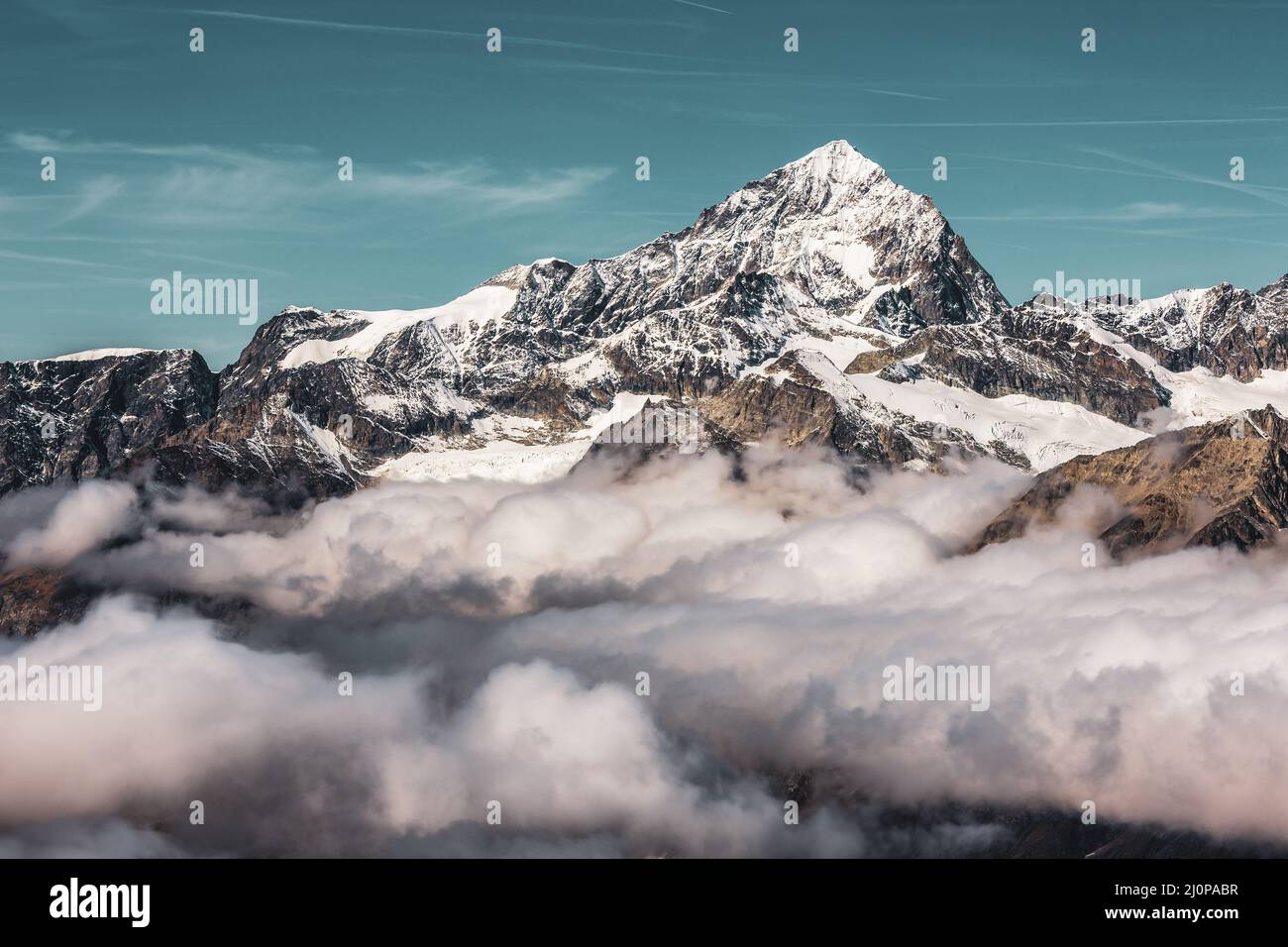 Swiss alps above the clouds Stock Photo - Alamy