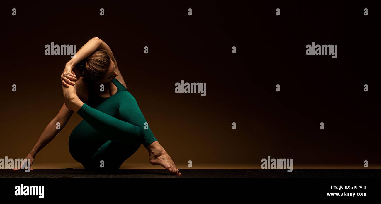 Attractive and beautiful young girl is twisting her body Stock Photo ...