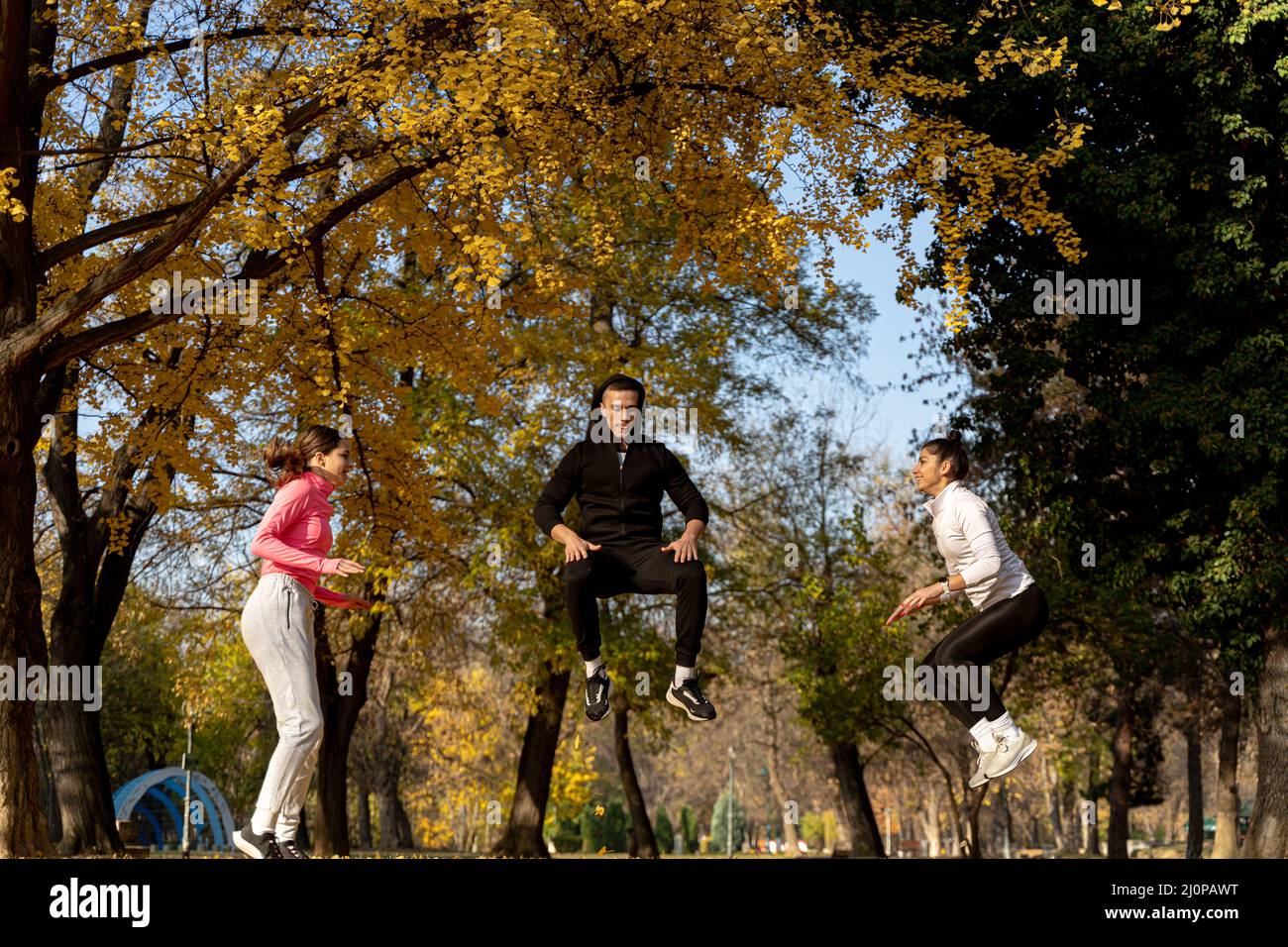 Three attractive and amazing fit friends are jumping high Stock Photo ...