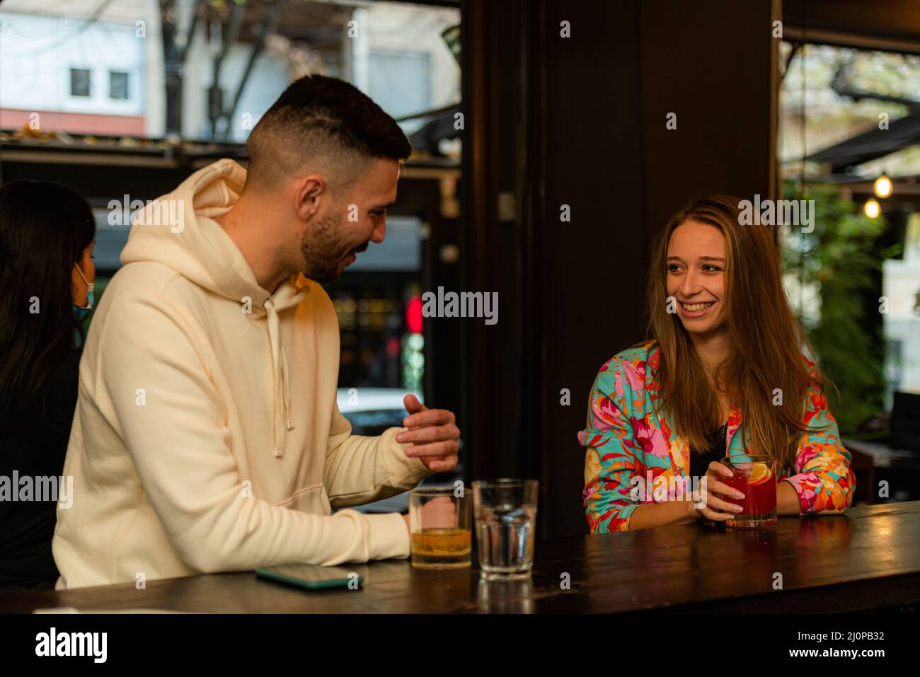 Attractive and handsome young guy is flirting with the girl while ...