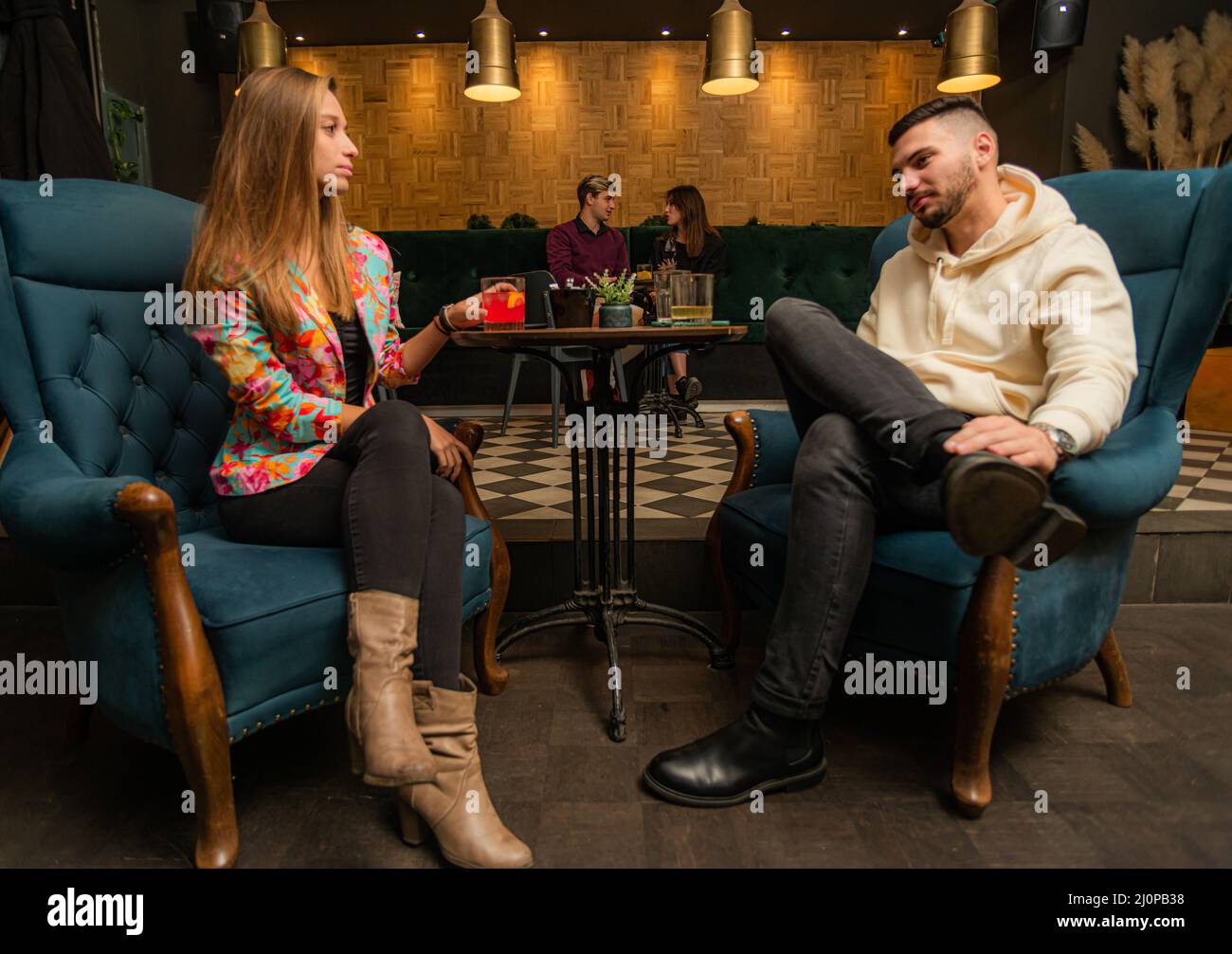 Two amazing and beautiful couples are sitting on their date Stock Photo ...