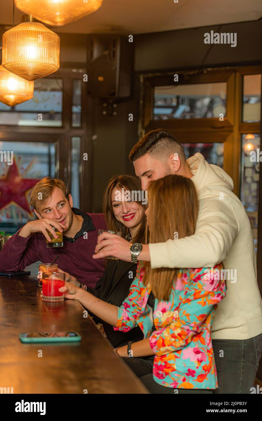 Two amazing and beautiful couples are having a fun discussion together ...