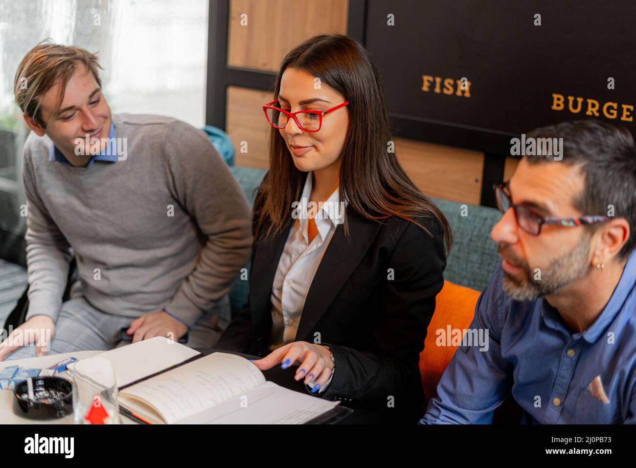 Three business people are making plans and giving ideas for the compnay ...