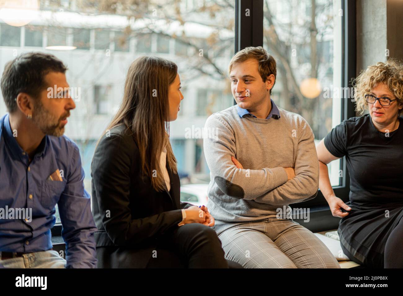 Group of amazing business people are having a serious talk in the cafe ...