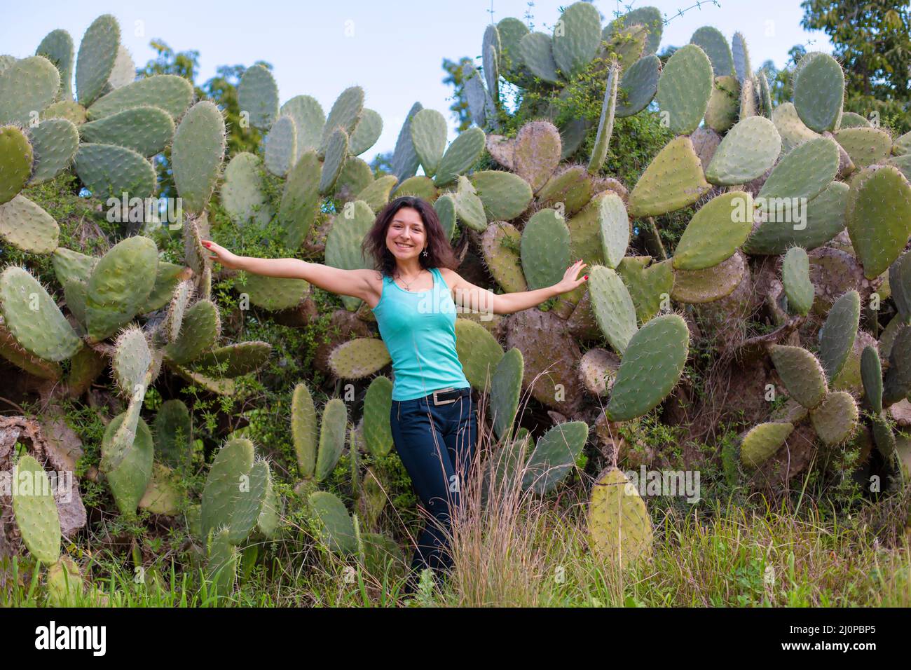 Beautiful girl posing in thickets of cacti Stock Photo - Alamy