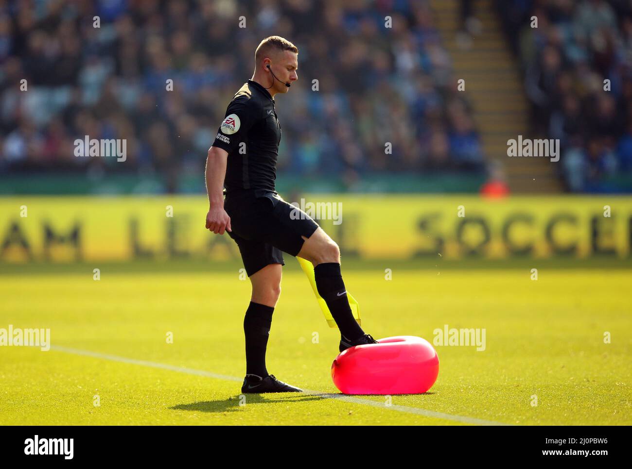 An assistant referee bursts a balloon thrown onto the pitch during the ...