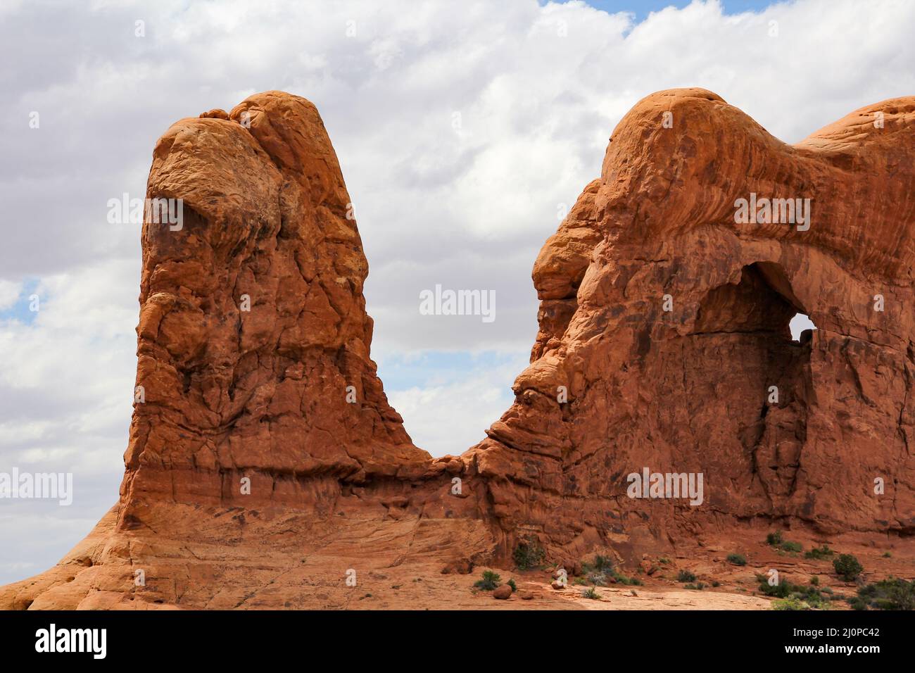 Tall cliffs of Arches National Park, with clouds in the background ...