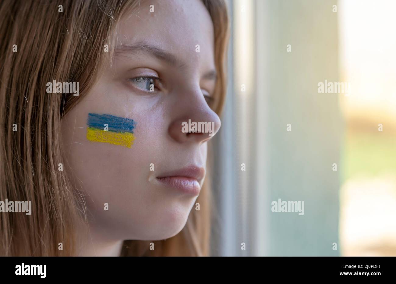 War. Russia's invasion of Ukraine. Portrait of a child with tears in ...
