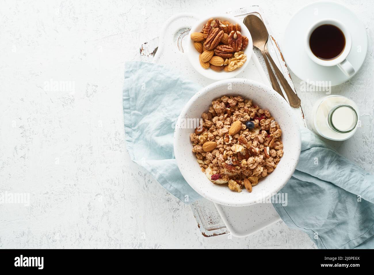 Dry granola in bowl. Breakfast, healthy diet food with milk in bottle ...