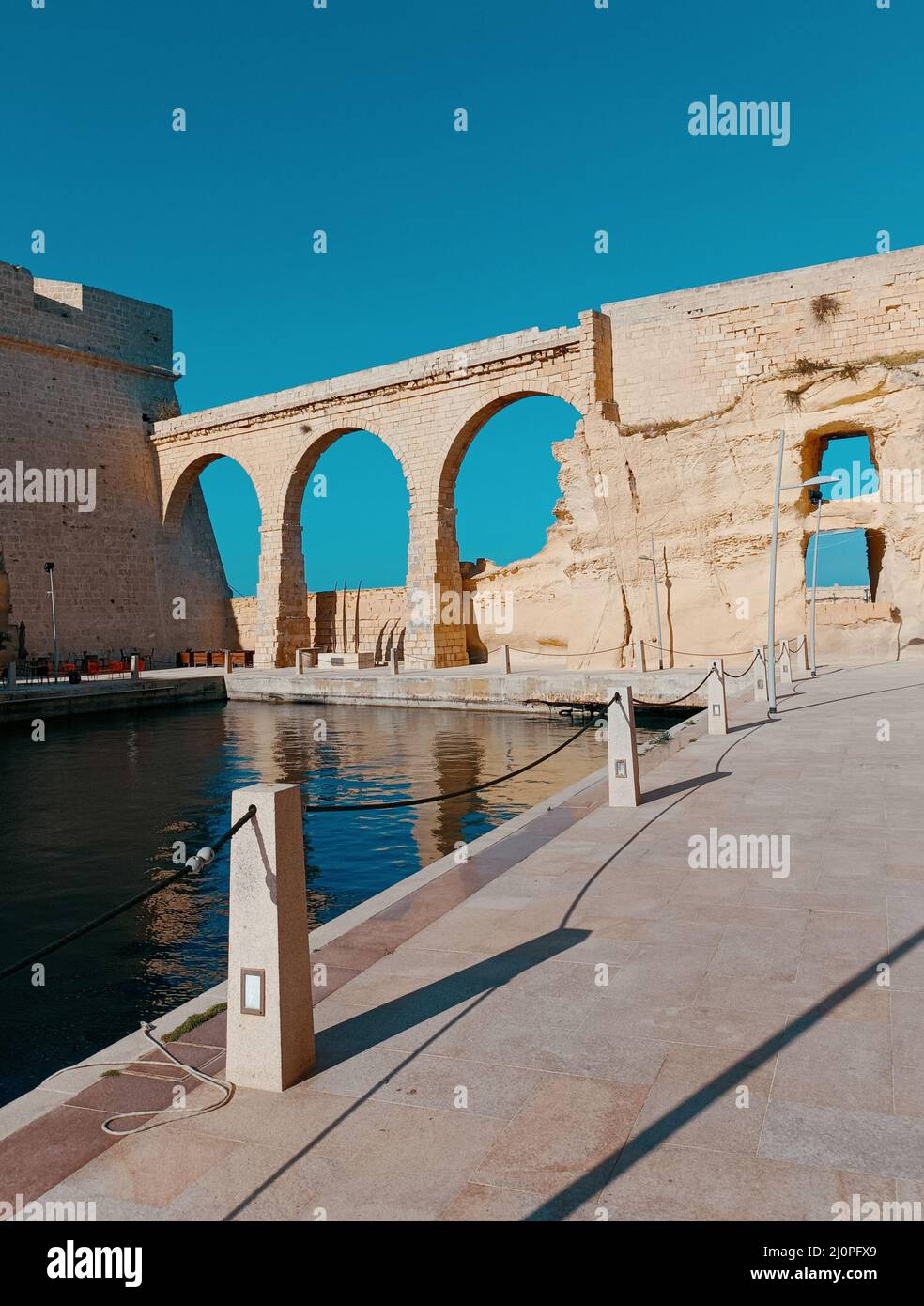 Beautiful shot of arches on fortifications of Birgu under a peaceful ...