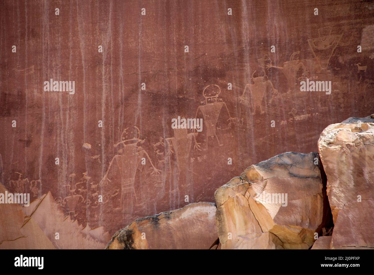 Shapes of people carved on the stone of a cliff Stock Photo - Alamy