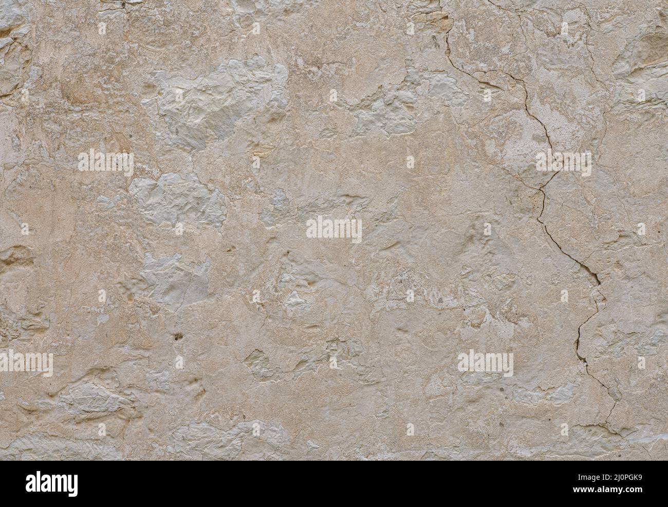 Beige stone wall with cracks. Stone background Stock Photo - Alamy