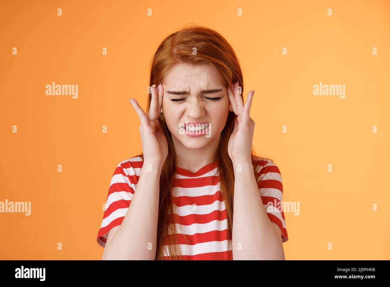 Dizzy uneasy cute redhead female student suffering huge headache ...