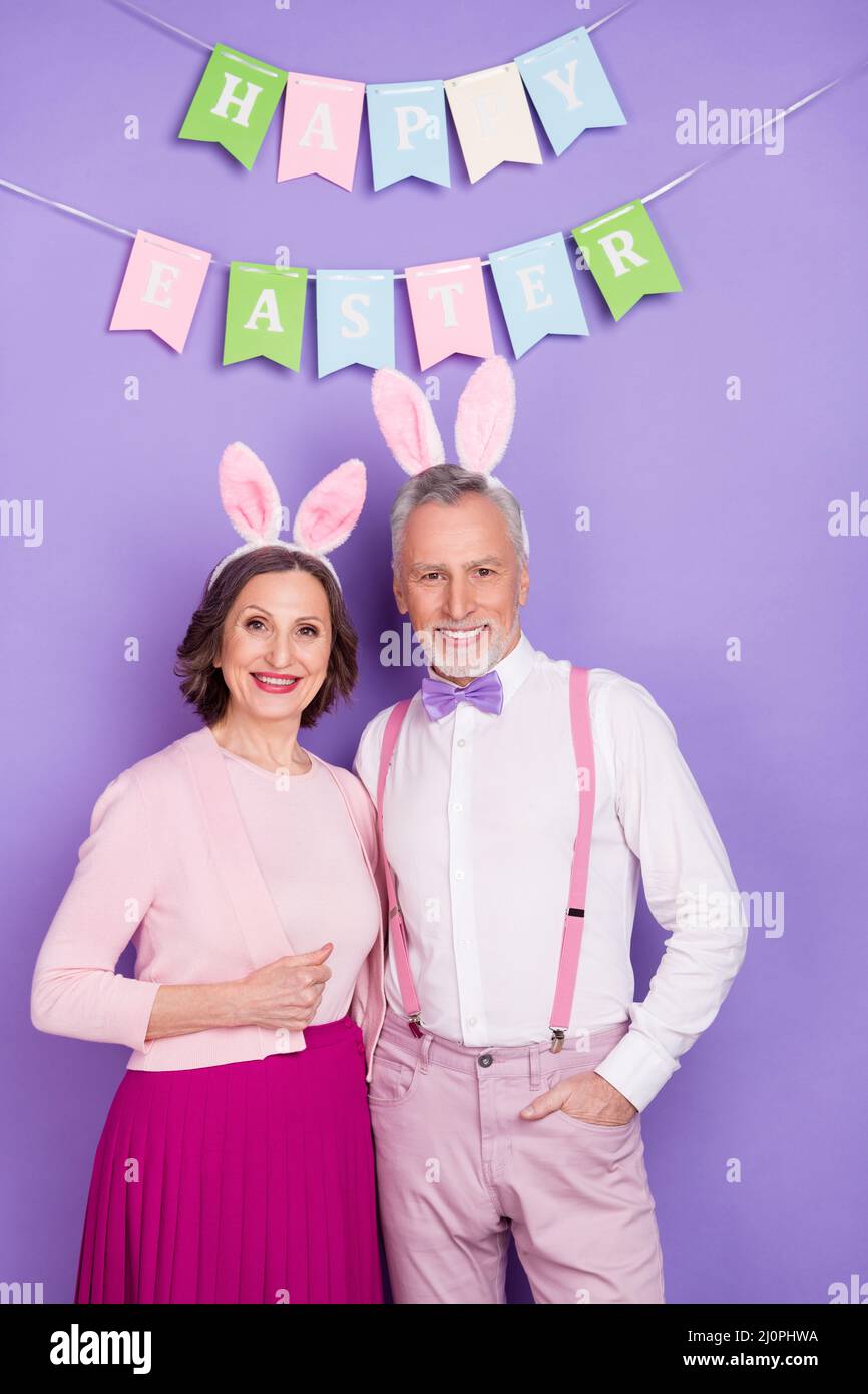 Vertical photo of positive cheerful partners bunny ears good mood look ...